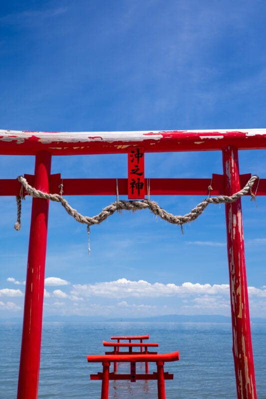 Serene Japanese Shrine Gate on Tranquil Waters | Offbeat Japan
